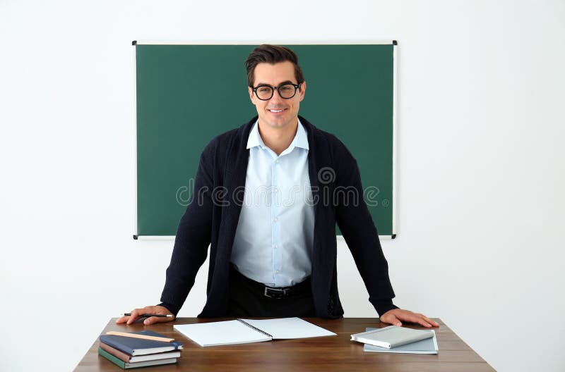 Young Teacher Standing Near Table in Stock Photo - Image of caucasian ...