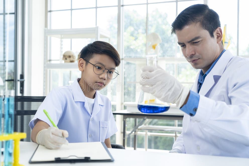 Young Teacher and Student Boy Use Microscope in Science Class at Laboratory Stock Image - Image ...