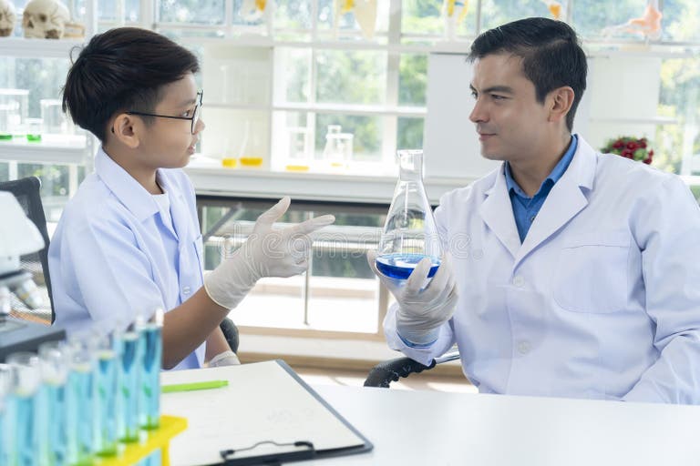 Young Teacher and Student Boy Use Microscope in Science Class at Laboratory Stock Photo - Image ...