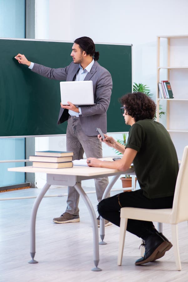 The Young Teacher and Student in the Classroom Stock Photo - Image of ...