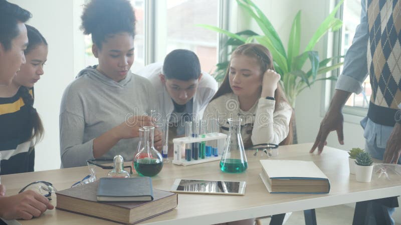 Young Teacher Teaching Group Student about Science and Explaining ...