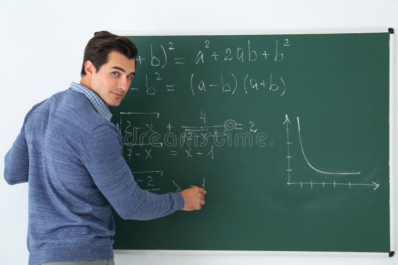 Young Teacher Writing Math Formulas on Chalkboard Stock Image - Image ...