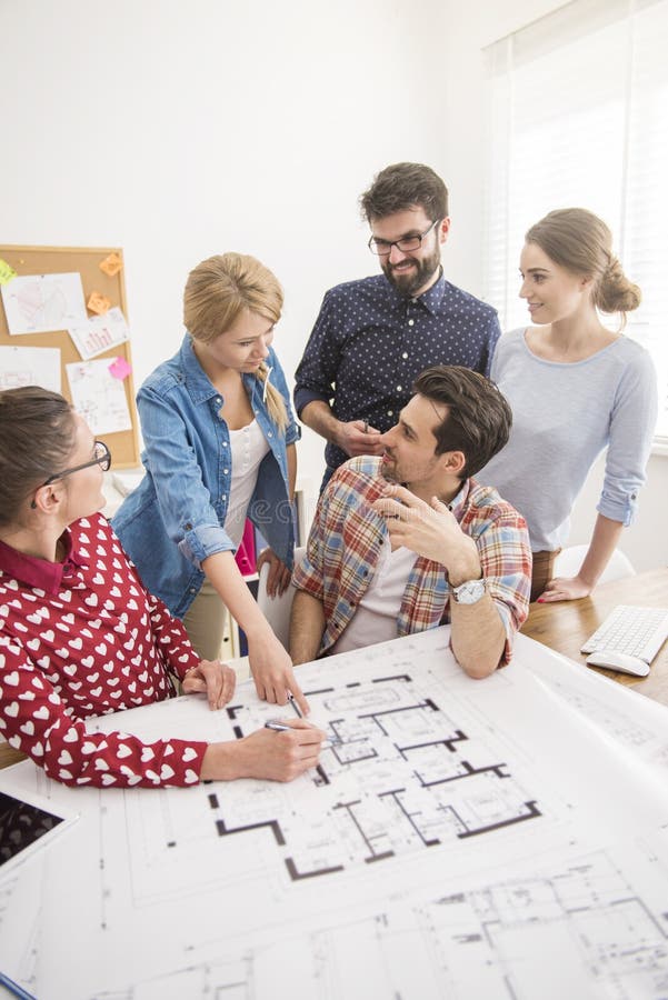 Young team of architects stock image. Image of brainstorming - 58746783
