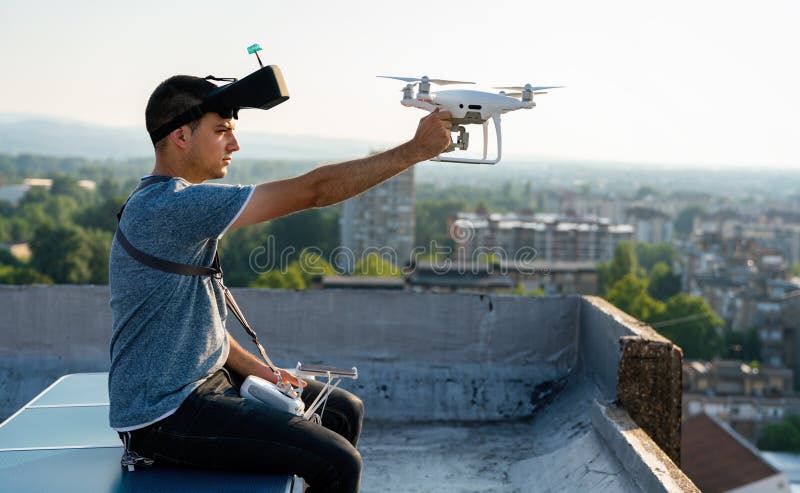 Young Technician Flying UAV Drone with Remote Control on Rooftop Stock ...