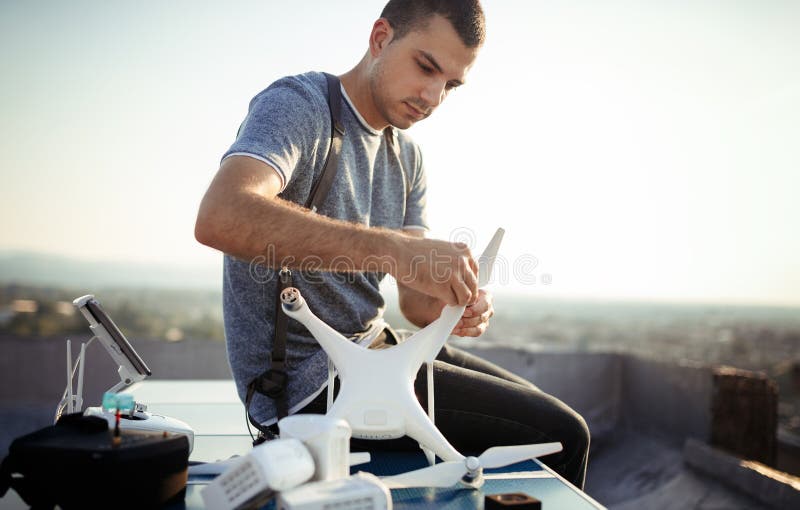 Young Technician Flying UAV Drone with Remote Control on Rooftop Stock ...