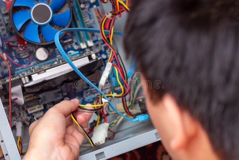 The Young Technician Hold the Screwdriver for Repairing the Computer in ...