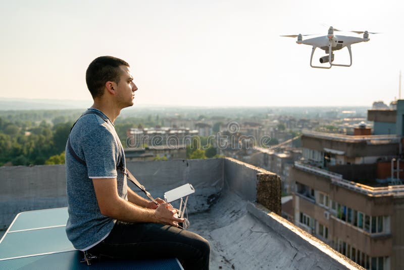 Young Technician Man Flying UAV Drone with Remote Control in City Stock ...