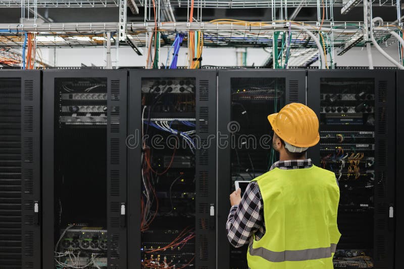 Young Engineer Man Working Inside Data Center Center Room while Wearing ...