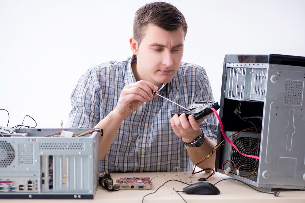 The Young Technician Repairing Computer in Workshop Stock Photo - Image ...