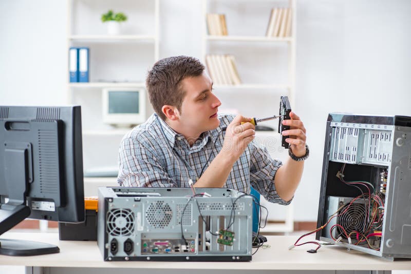 The Young Technician Repairing Computer in Workshop Stock Photo - Image ...