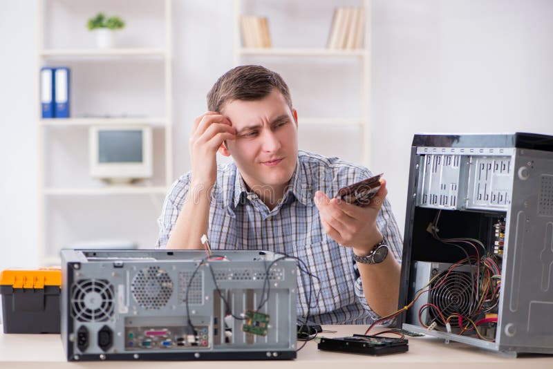 The Young Technician Repairing Computer in Workshop Stock Photo - Image ...