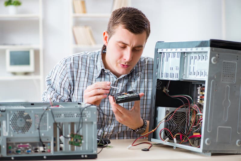 The Young Technician Repairing Computer in Workshop Stock Photo - Image ...