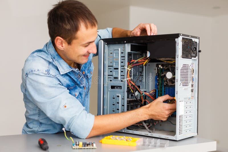 Young Technician Working on Broken Computer in His Office Stock Photo ...