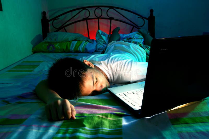 Young Teen Sleeping Front of a Laptop Computer and on a Bed Stock Image ...