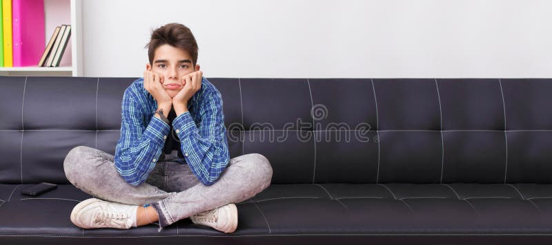 Teenager Boy on Sofa with Bored Expression Stock Photo - Image of space ...