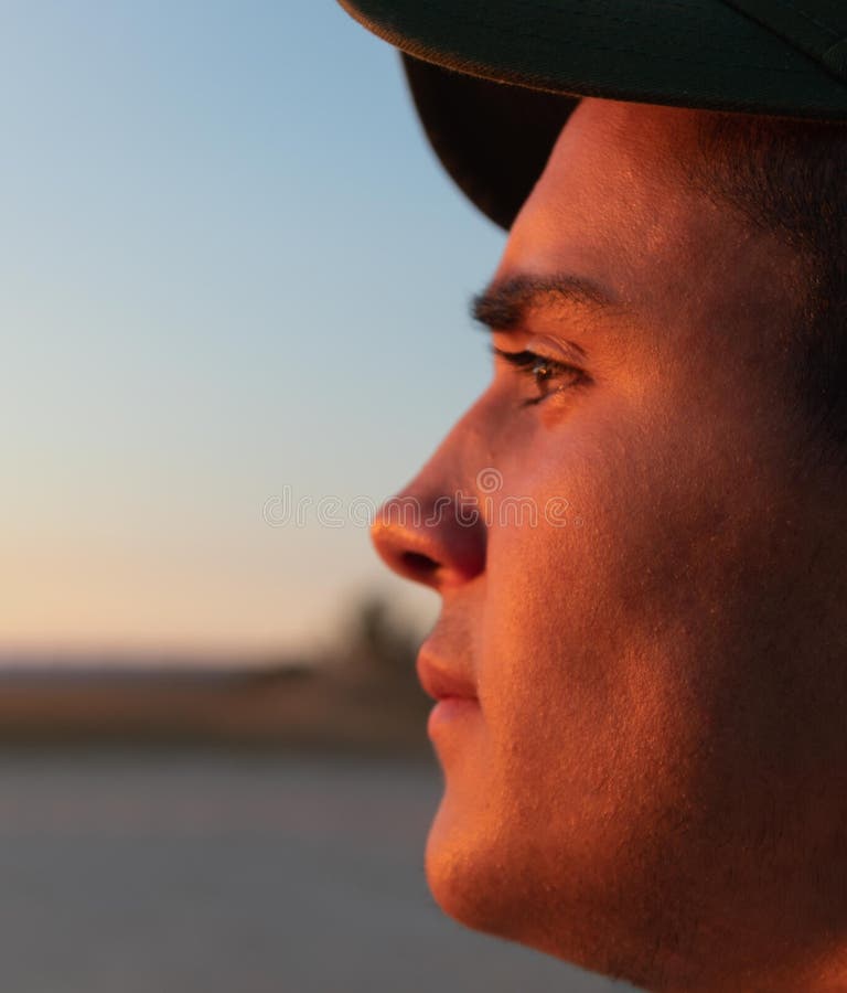 Young Teenager with Hat Facing Sideways and the Evening Sun Hitting Her ...