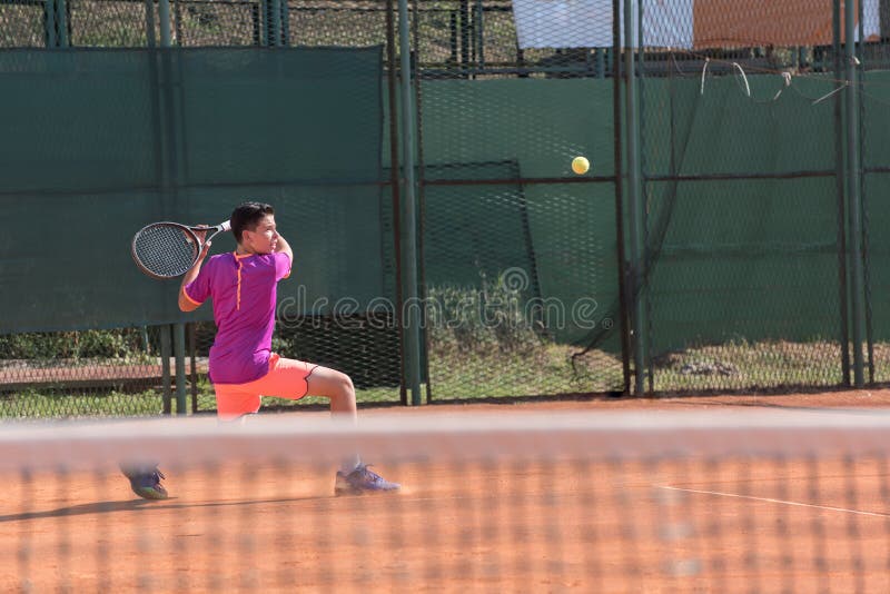 Young Tennis Player Hitting the Ball by Backhand Stock Image - Image of ...