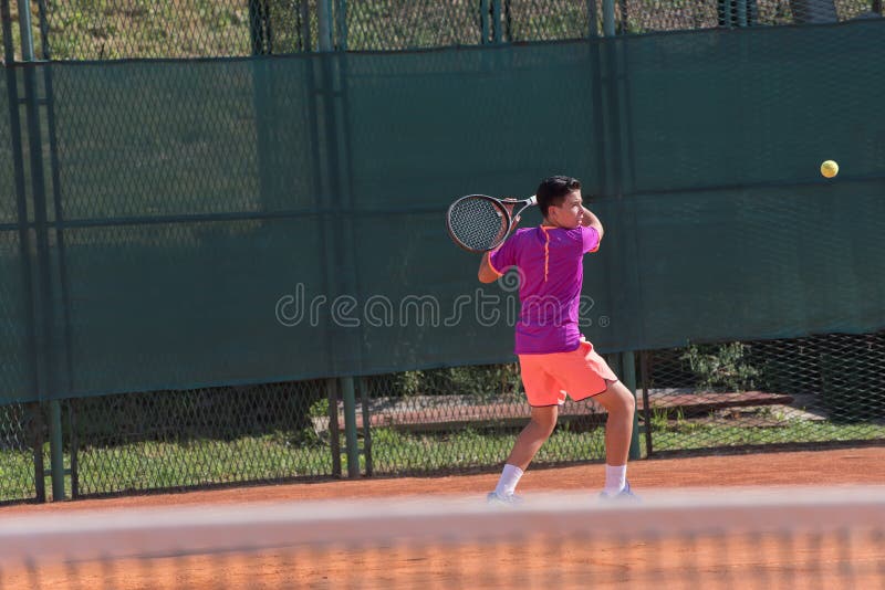 Young Tennis Player Hitting the Ball by Backhand Stock Image - Image of ...