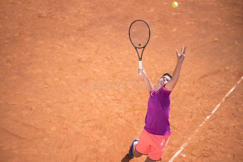 Young Tennis Player Serving the Ball with High Impact Stock Image ...