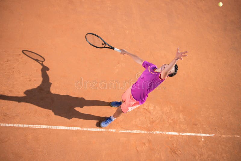 Young Tennis Player Serving the Ball with High Impact Stock Image ...