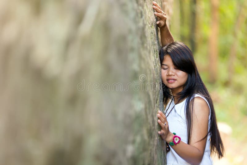 Young Thai Girl Holding Onto a Rock Stock Photo - Image of woman ...