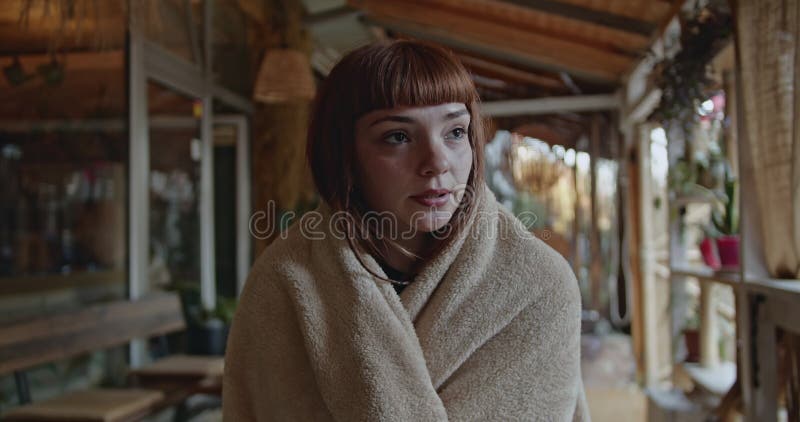 A Young Thoughtful Woman Wrapped in a Soft, Cozy Blanket, Looking ...