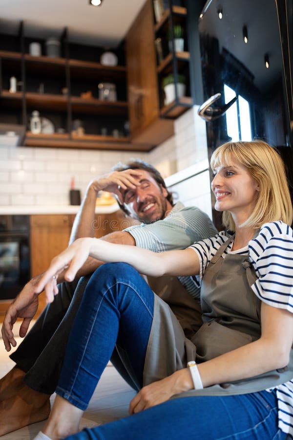 Young Happy Tired Couple Sitting on Kitchen Floor after Cooking Stock ...