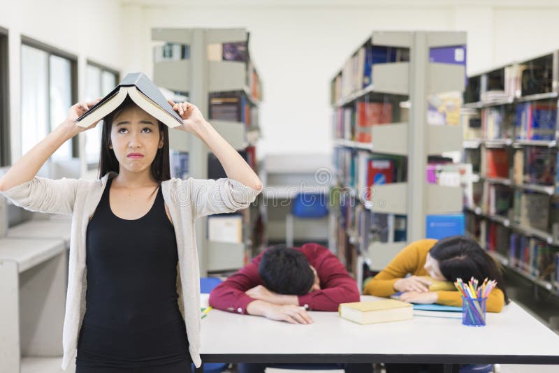 Students rest in library stock photo. Image of attractive - 105985814