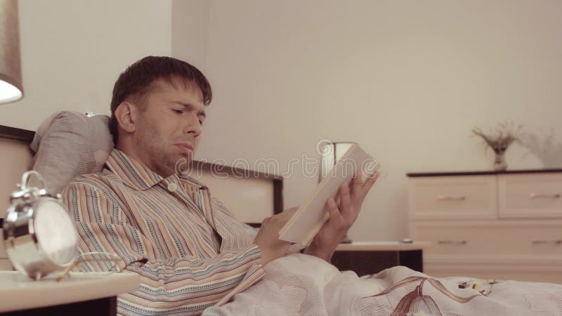 Young Touched Man Reading a Touching Book almost Crying Stock Video ...