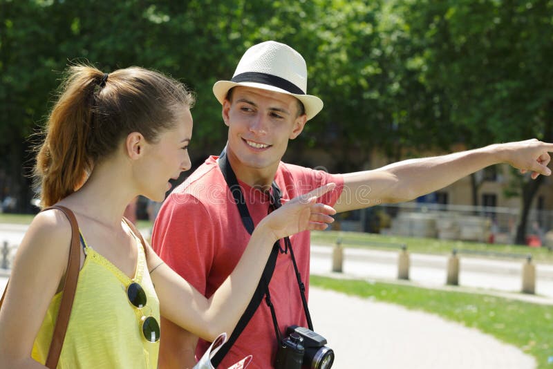 Young Tourist Couple Pointing into Distance Stock Photo - Image of ...