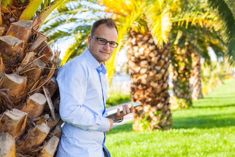 Young Tourist Under Palm Tree with Mobile Tablet Pc. Stock Photo ...