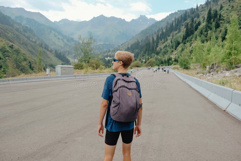 Young Traveler with a Backpack on the Road Enjoying View of the ...