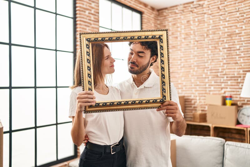 Young Two People Holding Empty Frame Together Smiling Looking To the ...