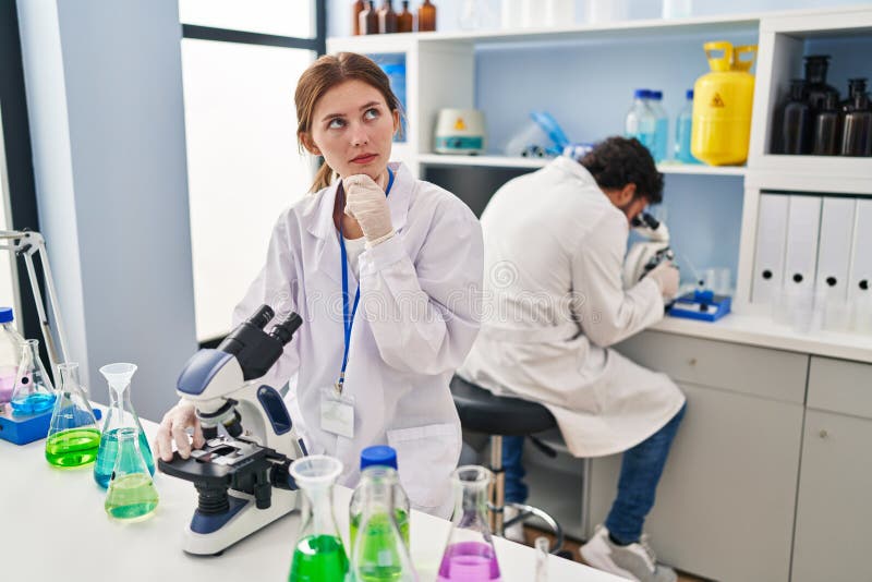 Young Two People Working at Scientist Laboratory Serious Face Thinking ...