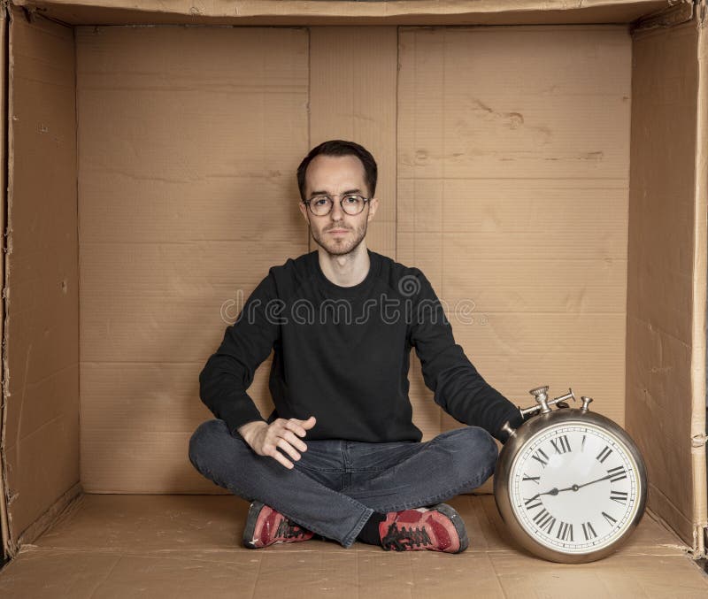 Young Unemployed Student Sits in a Tight Cardboard Box, the Idea of ...