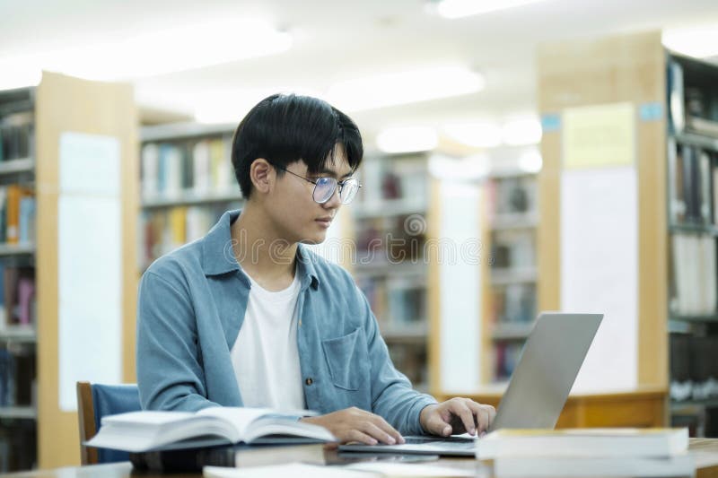 Young University Student Using Laptop for Online Learning, Searching ...