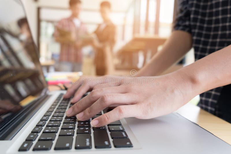 University Students Sitting Together at Table with Books and Laptop ...