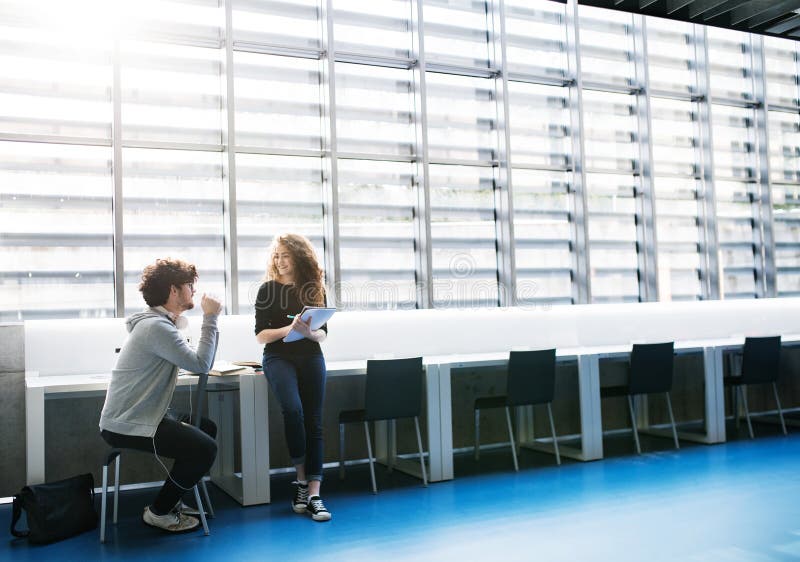 Young University Students Studying Togeter in Library, Talking ...