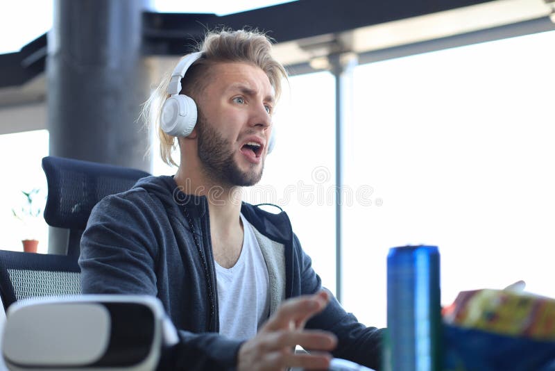 Young Upset Gamer Playing Online Video Games on Computer and Feel ...