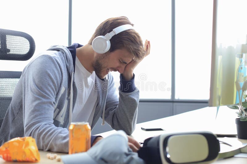 Young Upset Gamer Playing Online Video Games on Computer and Feel ...