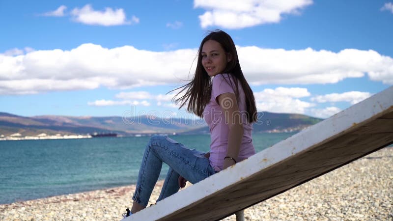 Young and Very Attractive Girl Lean Back on the Beach and Look in ...