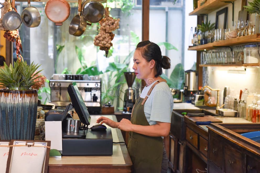 Young Vietnamese Waitress Working with Check Out Machine in Cafe Stock ...