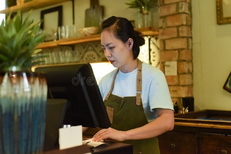 Young Vietnamese Waitress Working with Check Out Machine in Cafe Stock ...
