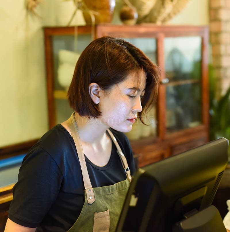 Young Vietnamese Waitress Working with Check Out Machine in Cafe Stock ...