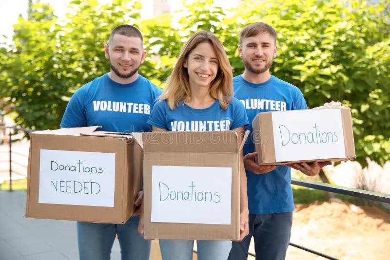 Three Volunteers Packing Eatables in Cardboard Box Stock Image - Image ...