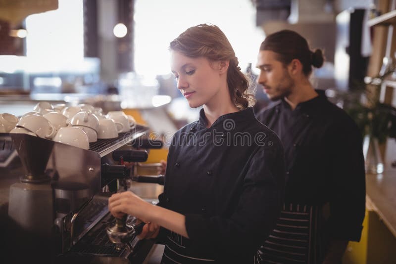 Young Wait Staff Using Espresso Maker at Coffee Shop Stock Image ...