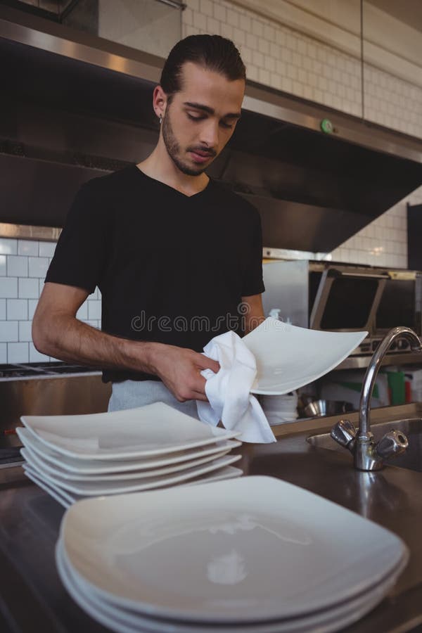 Waiter Cleaning Plates in Cafe Stock Image - Image of holding ...