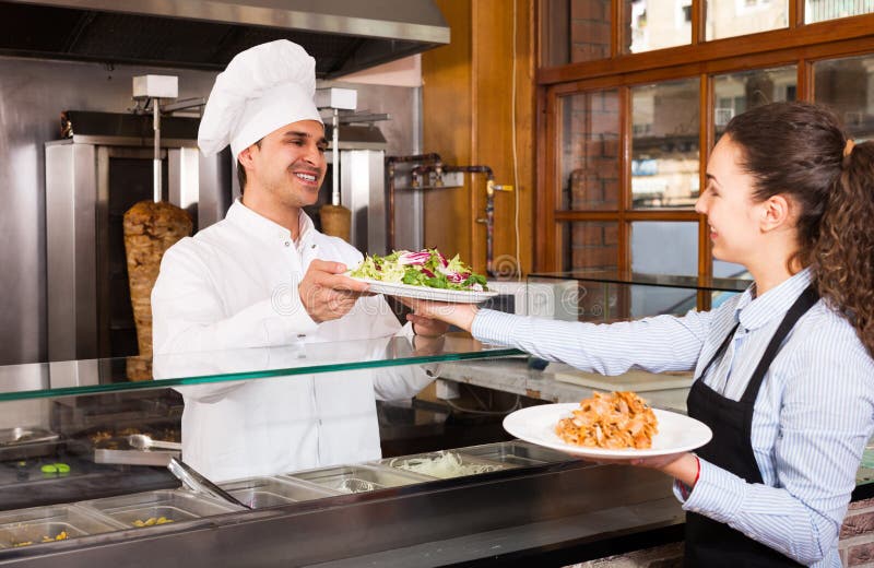 Young Waitress Holding Tray with Dishes Meeting Visitors Stock Photo ...