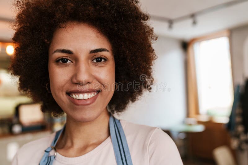 Young Waitress Smiling at Camera while Standing in Cafe Stock Image ...