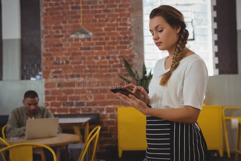 Waitress Using Digital Tablet at Cafe Stock Photo - Image of cafe ...
